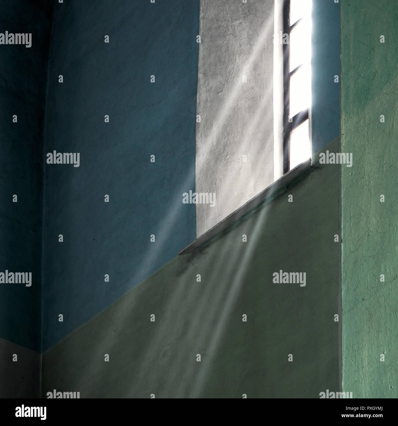 Sun rays make their way through the high vaulted arched window under ...