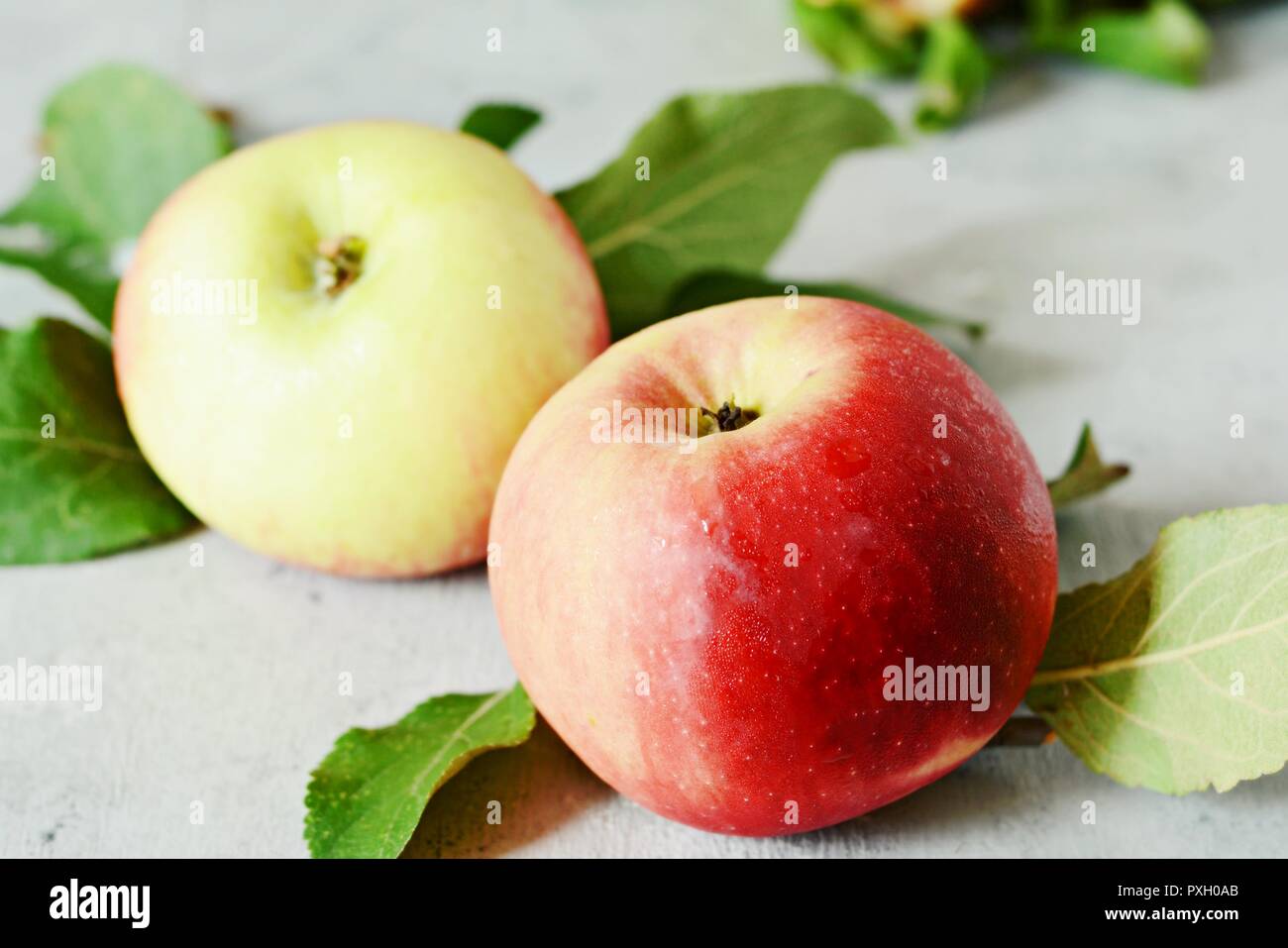 Fresh apple fruits close up, juicy red apples with green leaves Stock ...