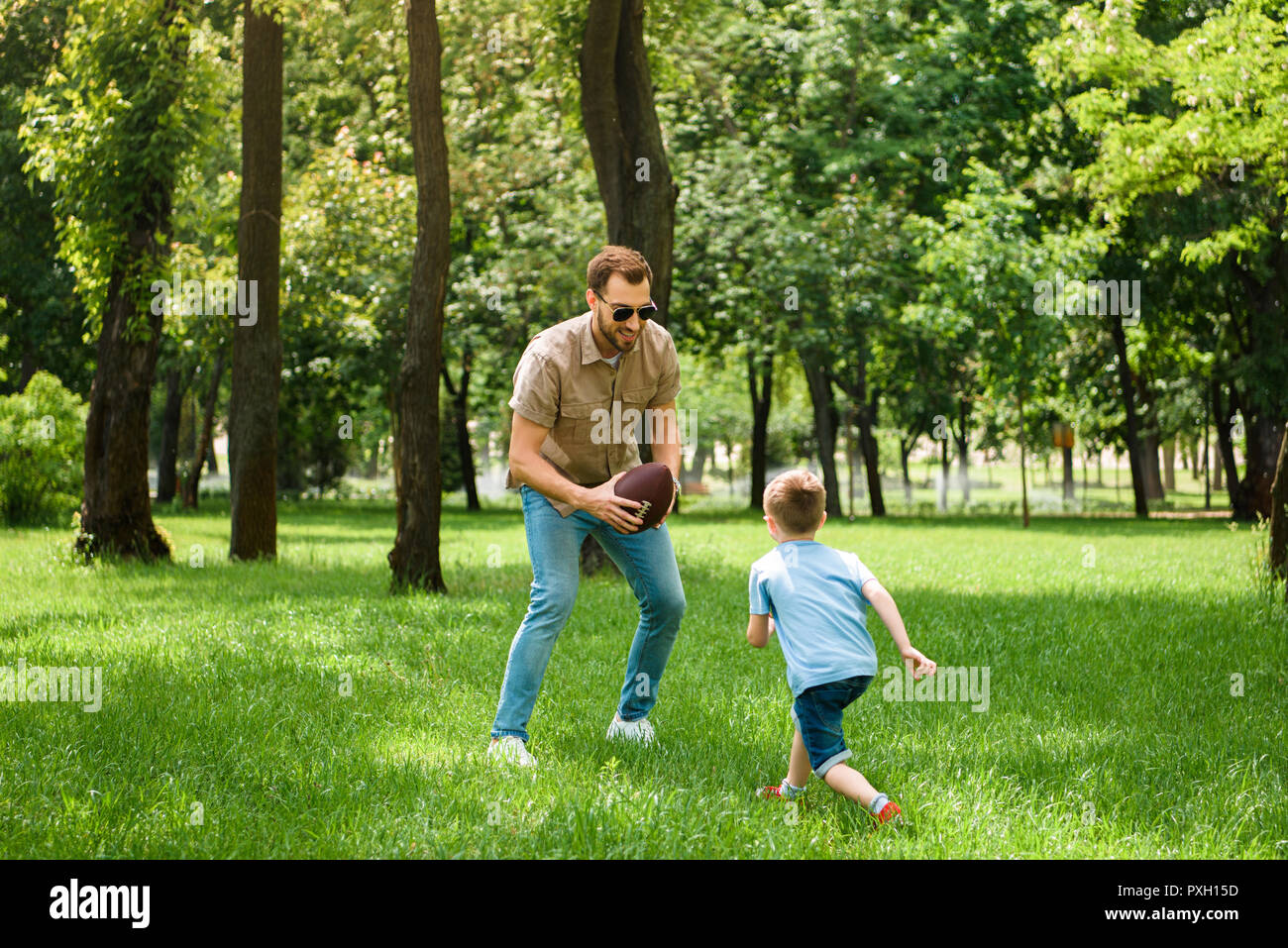 Father teaching son football hi-res stock photography and images - Alamy