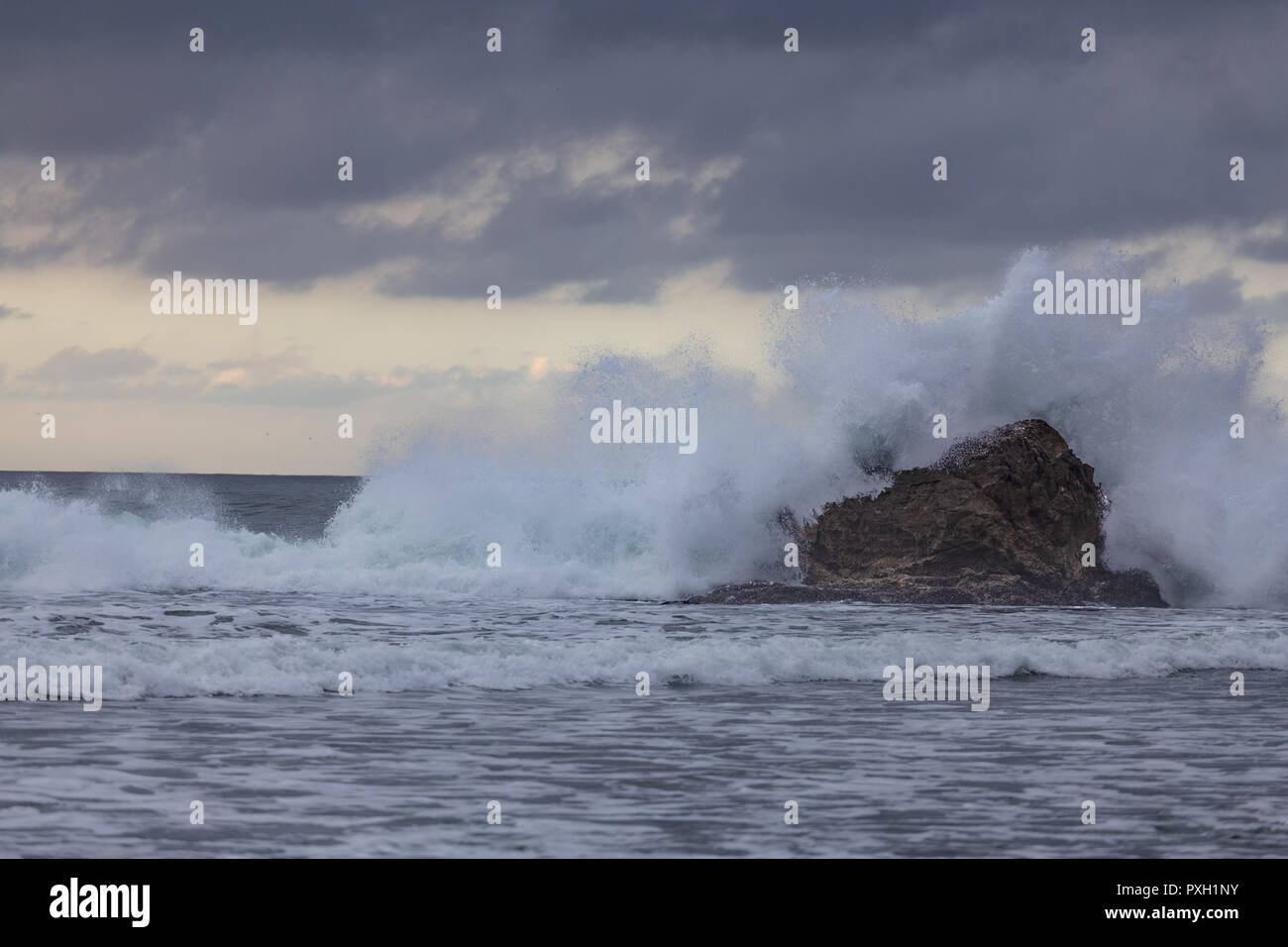 Wave crashing against rock on the beach hi-res stock photography and ...