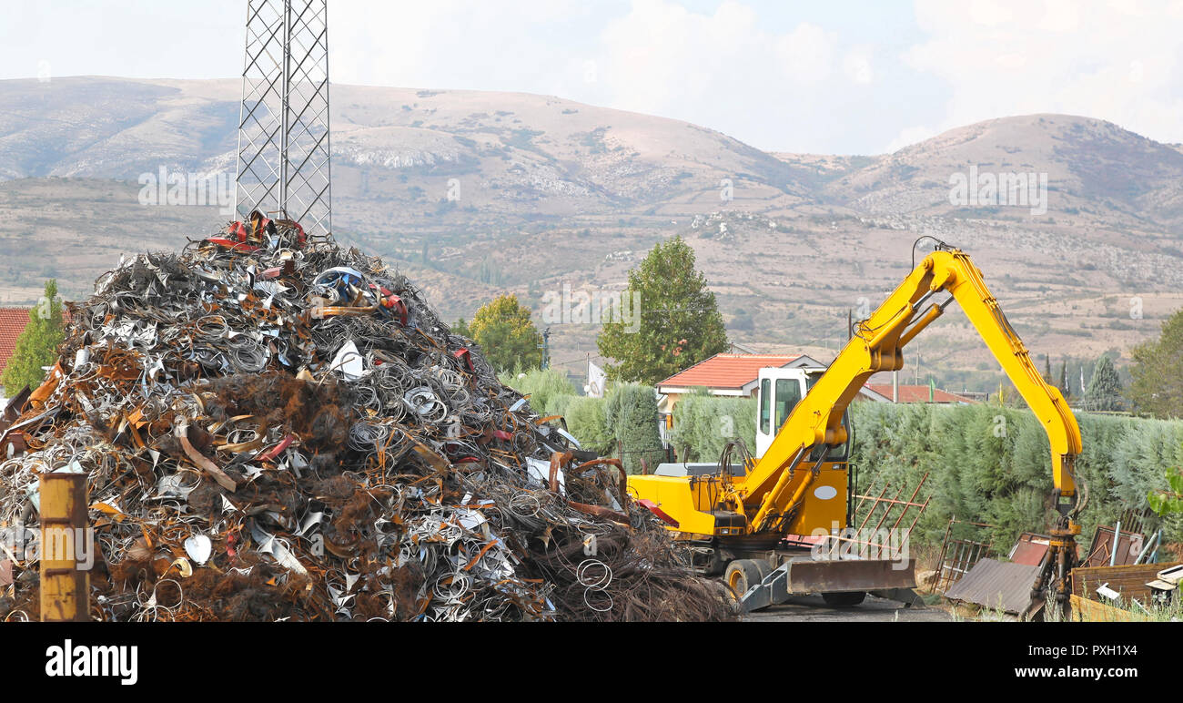 Pile of Scrap Metal and Digger at Recycling facility Stock Photo - Alamy