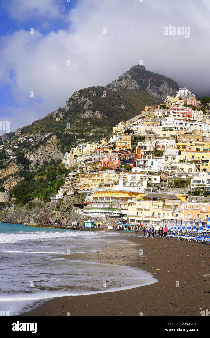 Beach with the backdrop of colorful homes on a steep mountain in ...