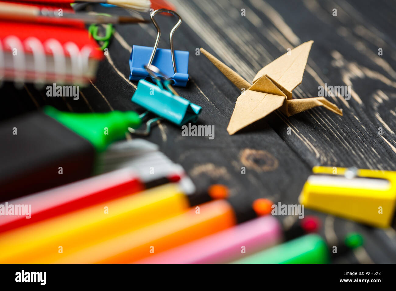 Origami on the background of the school stationery Stock Photo - Alamy