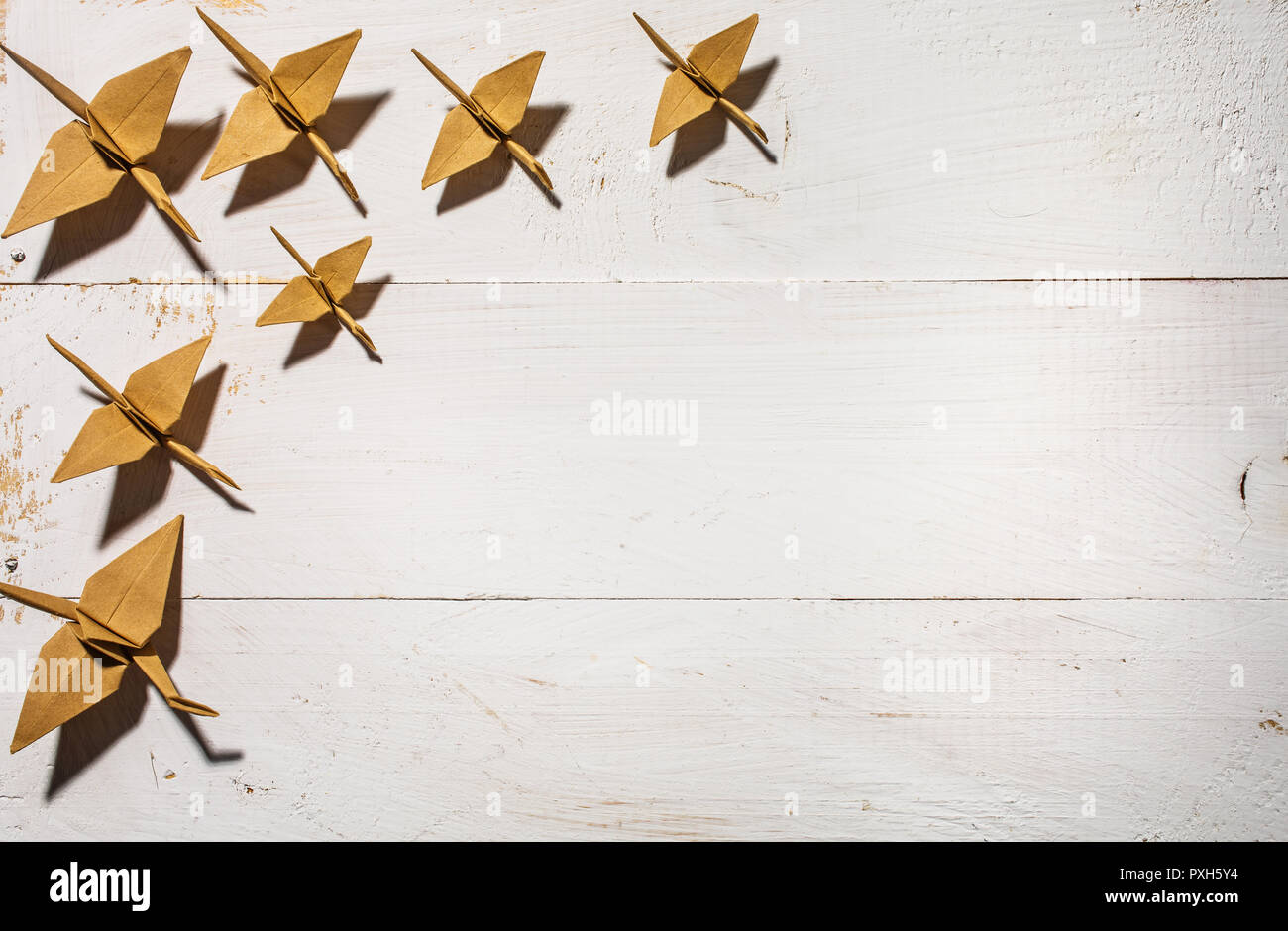 White wooden background with origami. Background for the text Stock ...