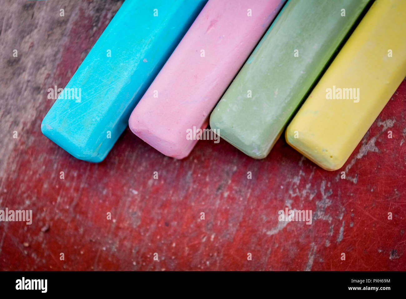Colored chalk sticks on old wood board as copy space background ...