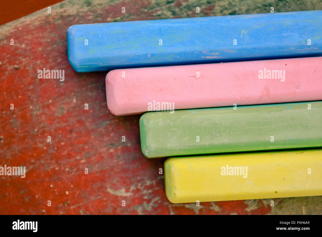 Colored chalk sticks on old wood board as copy space background ...
