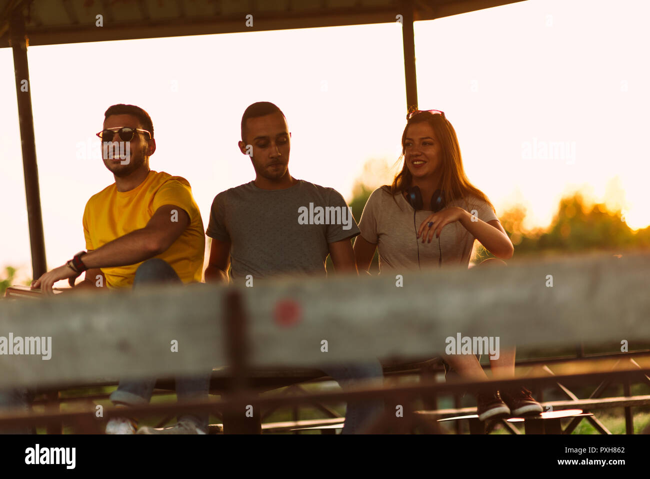 Friends chatting on a bench Stock Photo - Alamy