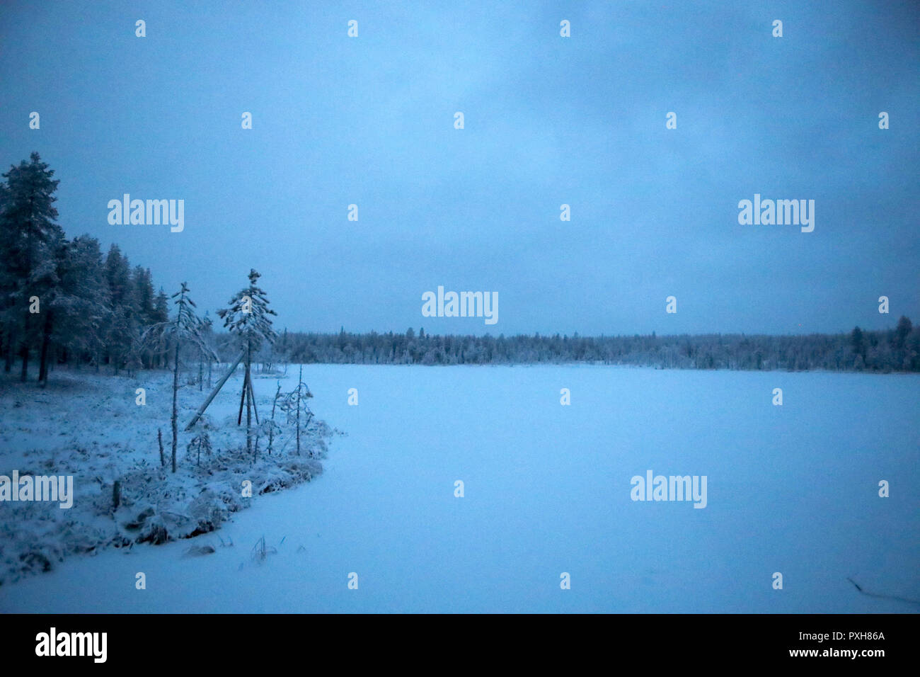 A view of a frozen lake near Rovaniemi, Finland. Rovaniemi is the ...