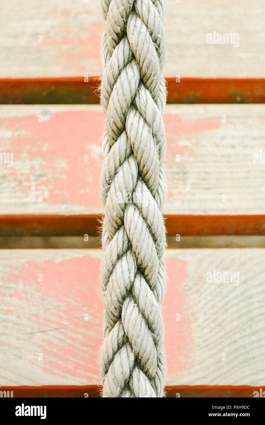 Old rope on background of distressed red painted wood planks Stock ...