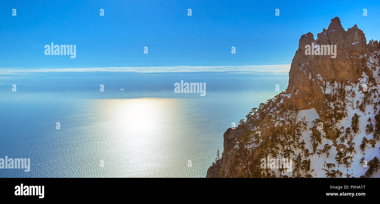 Large flat surface of water, with reflection of sunlight, to the right ...