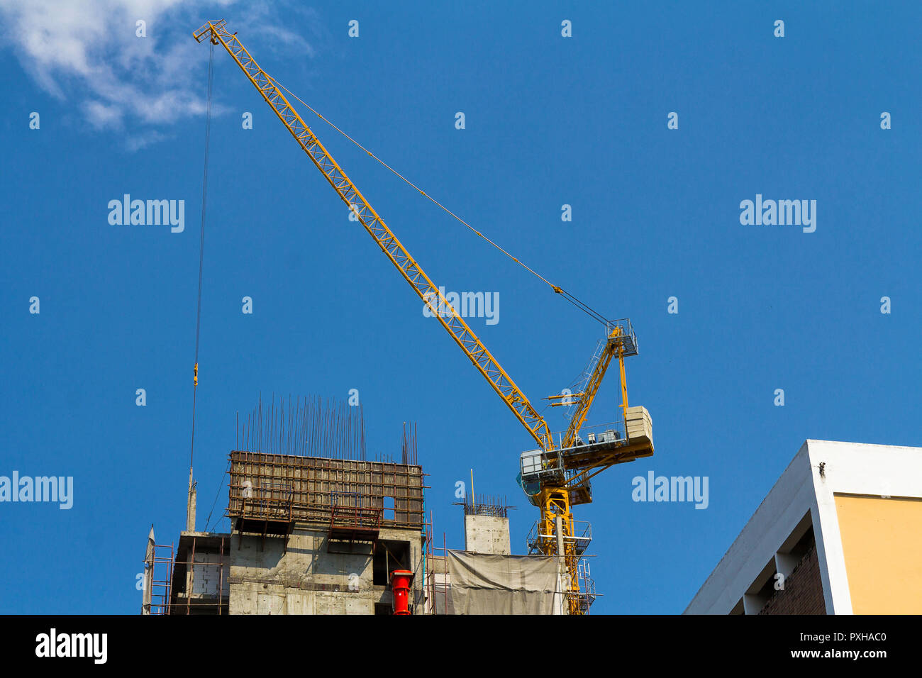 Lifting crane and building in construction site Stock Photo - Alamy