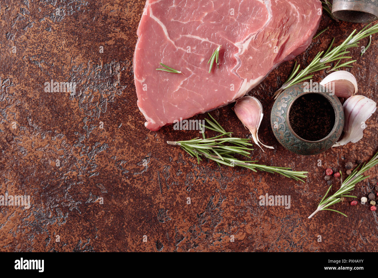 Raw beef steak with spices and herbs. Top view Stock Photo - Alamy