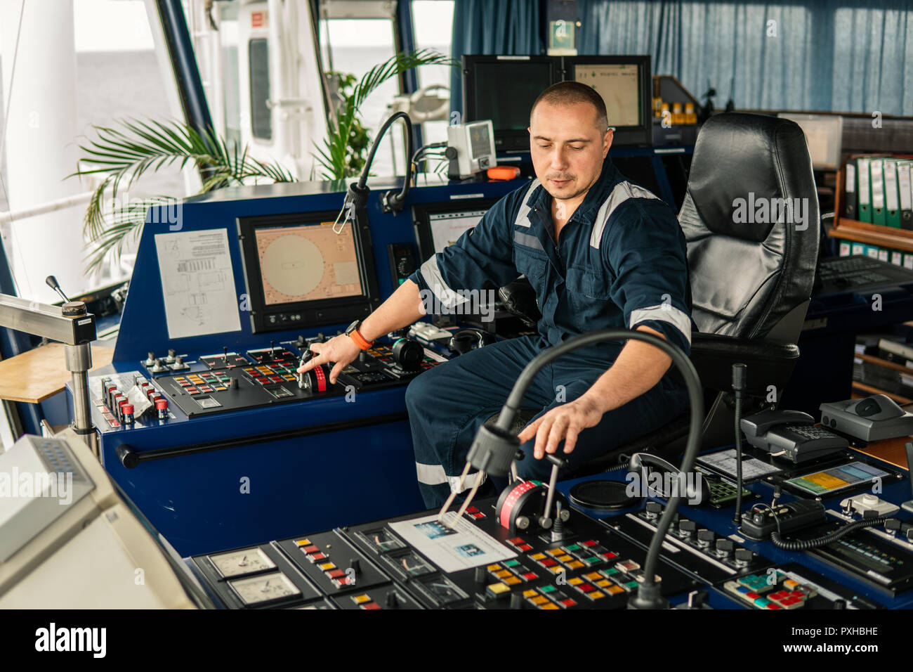 Marine navigational officer is maneuvering ship or vessel Stock Photo ...