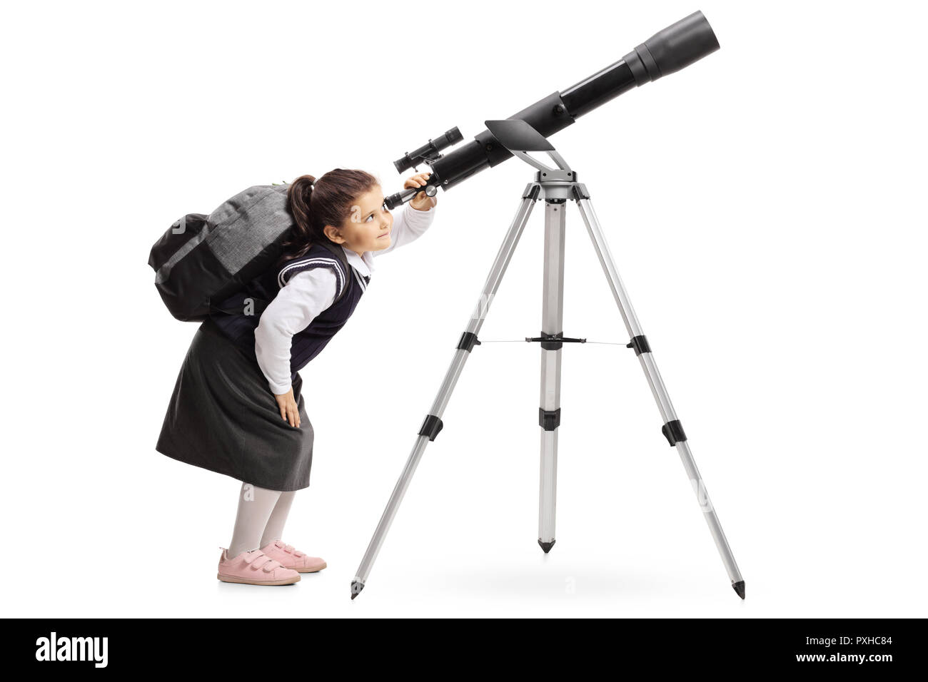 Schoolgirl with a backpack looking through a telescope isolated on ...