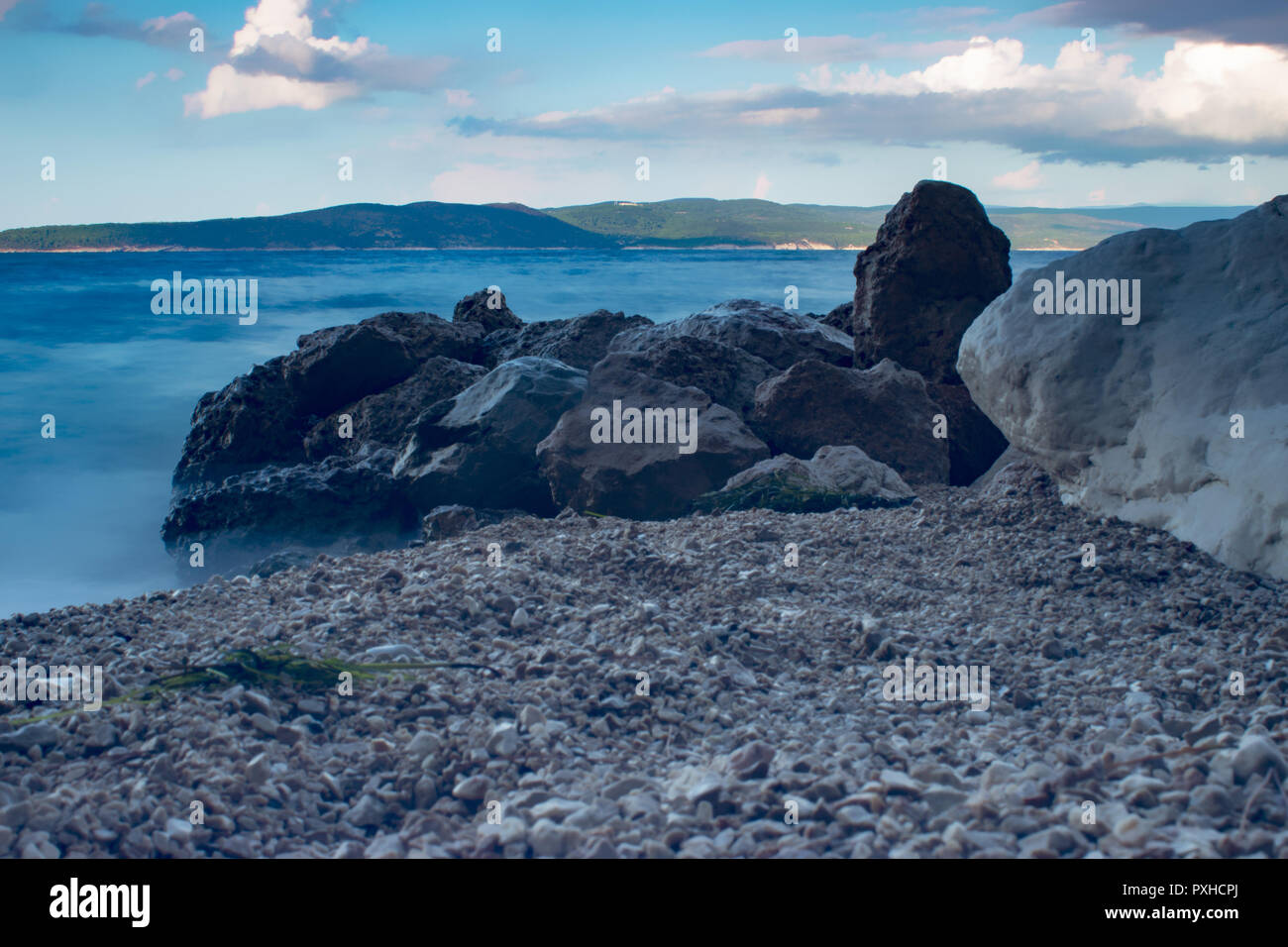 Surf waves of the sea in Croatia with stones on the beach. Waves lap ...