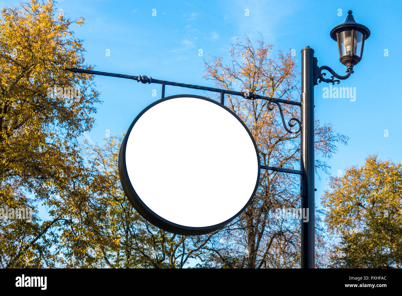 Blank round signboard, advertising, information board on pole in the ...