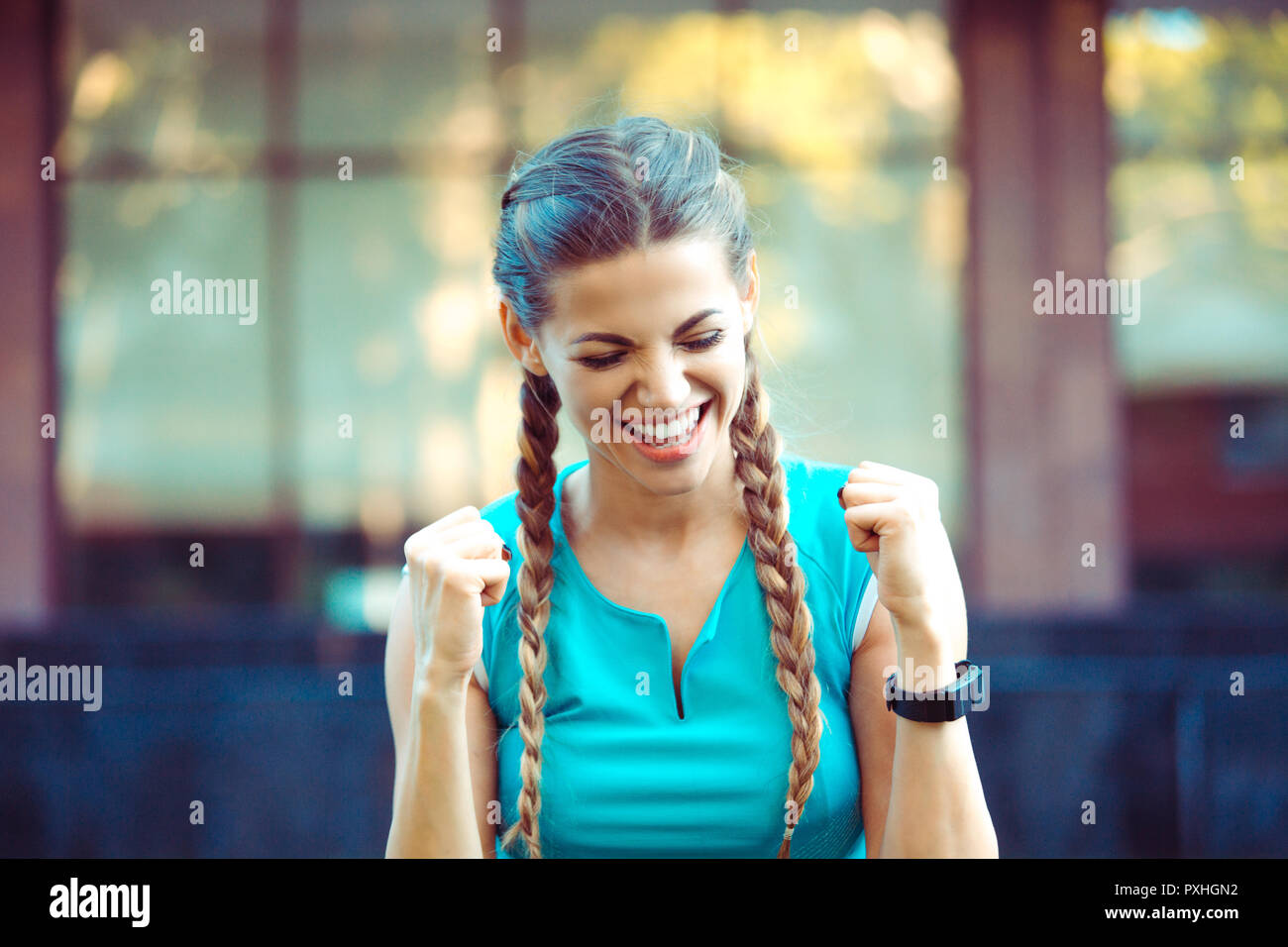 Excited sportive woman celebrating win Stock Photo - Alamy
