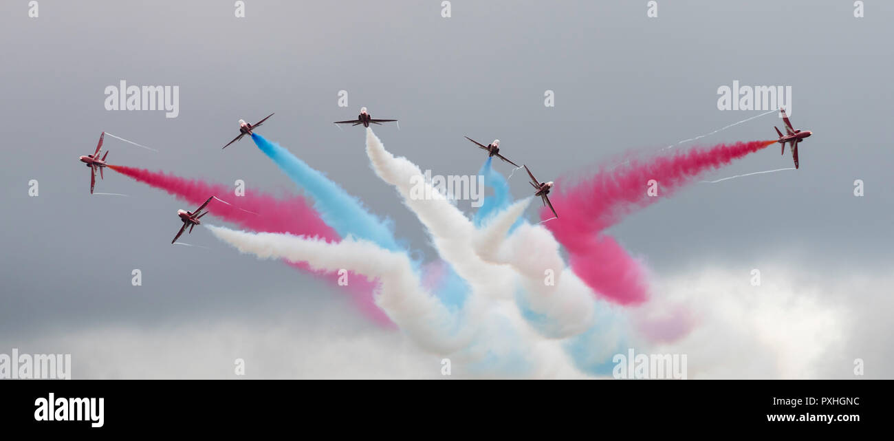 Red, white and blue smoke trails from the Red Arrows aerobatic display ...