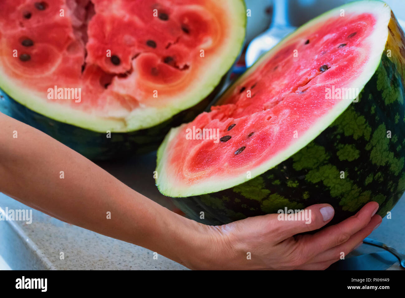 Watermelon cut in two halves hi-res stock photography and images - Alamy