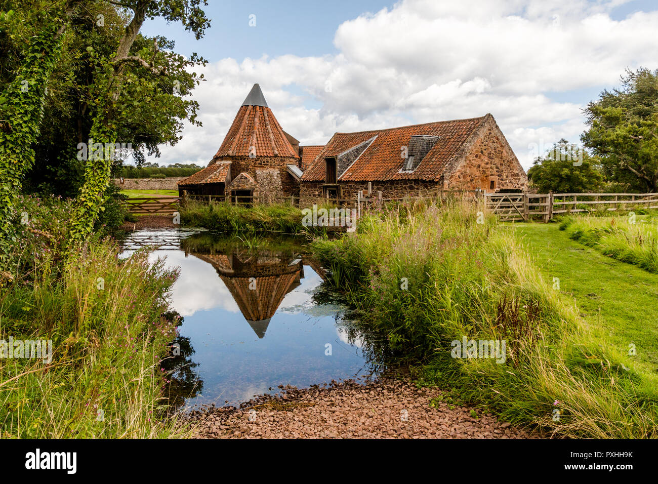 Preston Mill with conical pantiled kiln building reflected in the mill ...