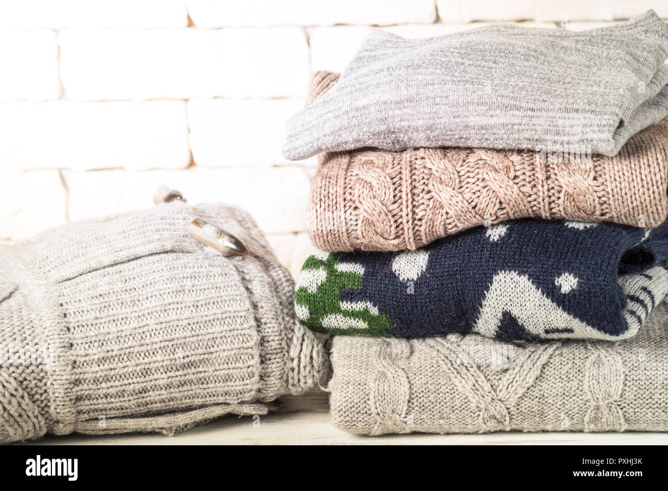 Stack of cozy woolen clothes on white Stock Photo - Alamy
