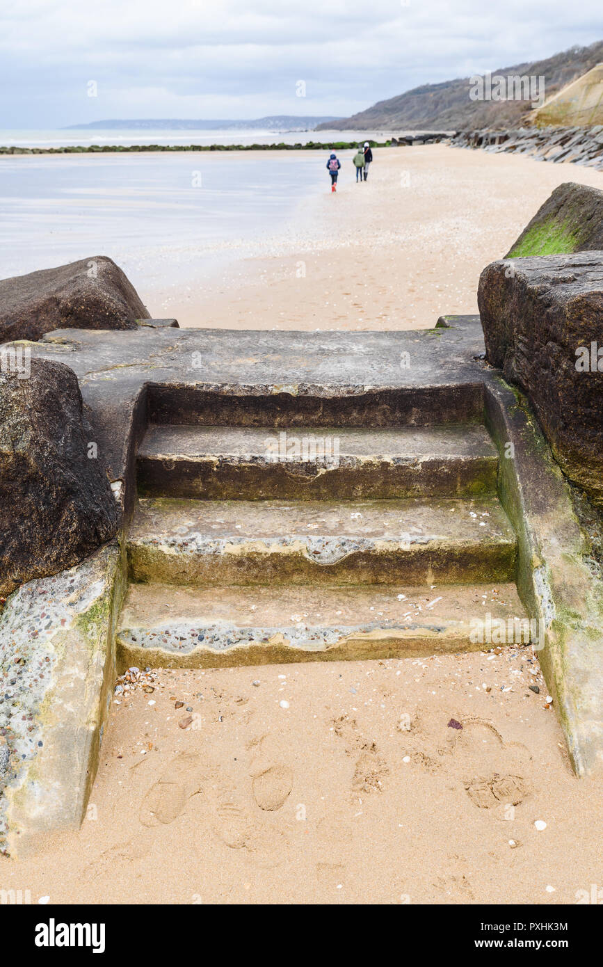 Stairway on the stone wall barrier on the beach in Normandy, France ...