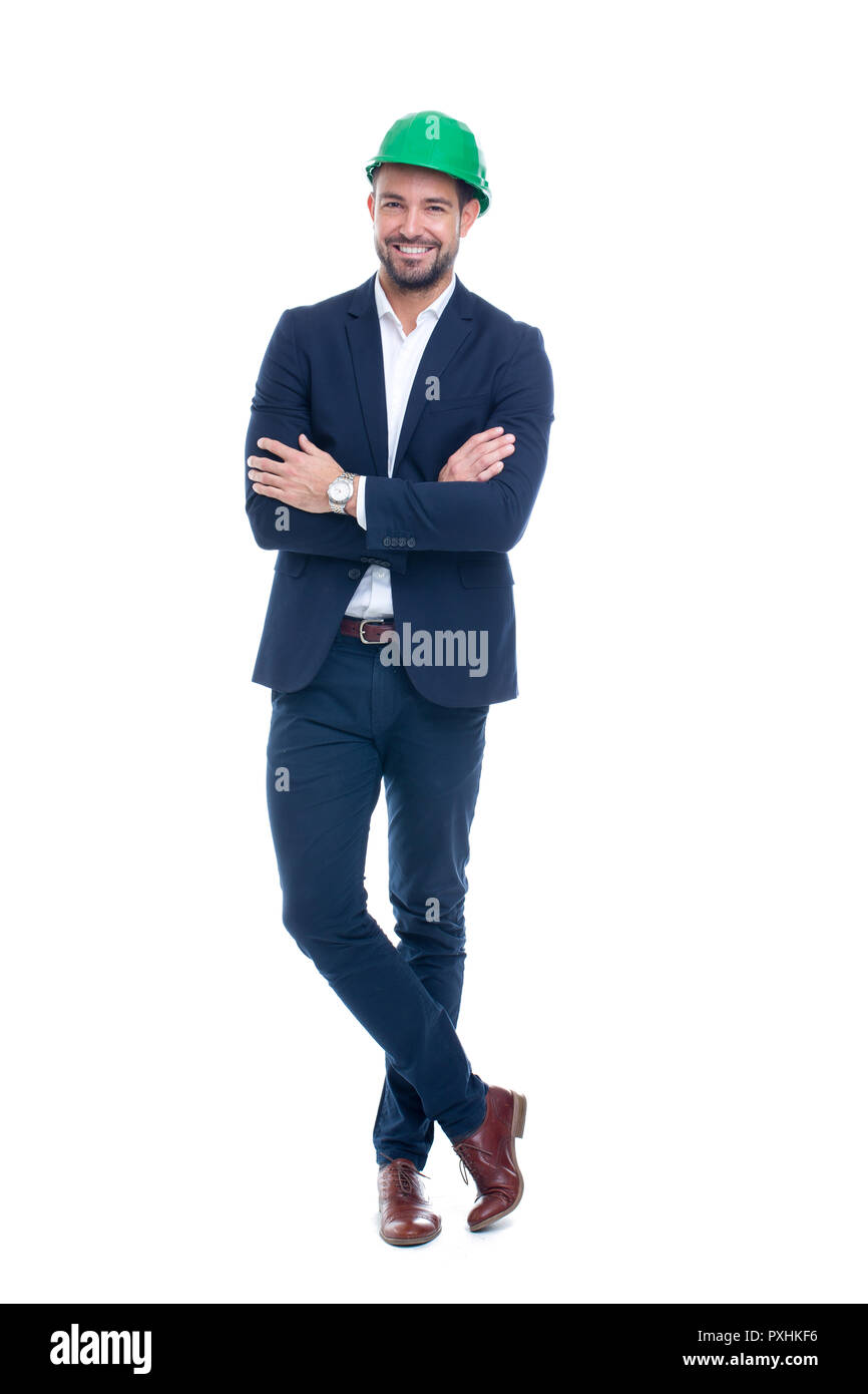 Confident engineer in green helmet and formal wear posing, isolated on ...