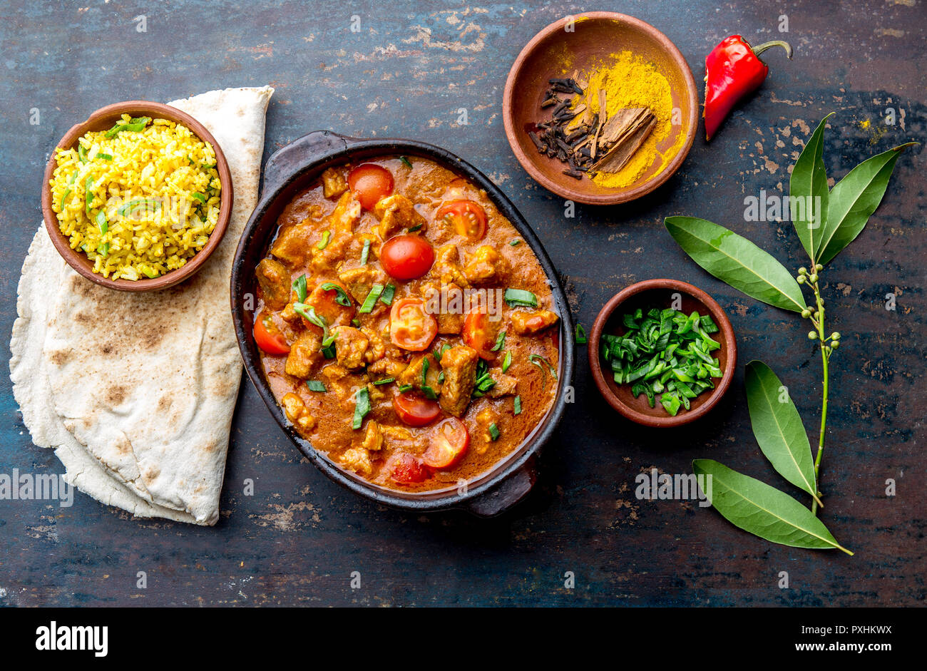 INDIAN FOOD. ROGAN JOSH curry sauce. Pork rogan josh with rice and naan ...