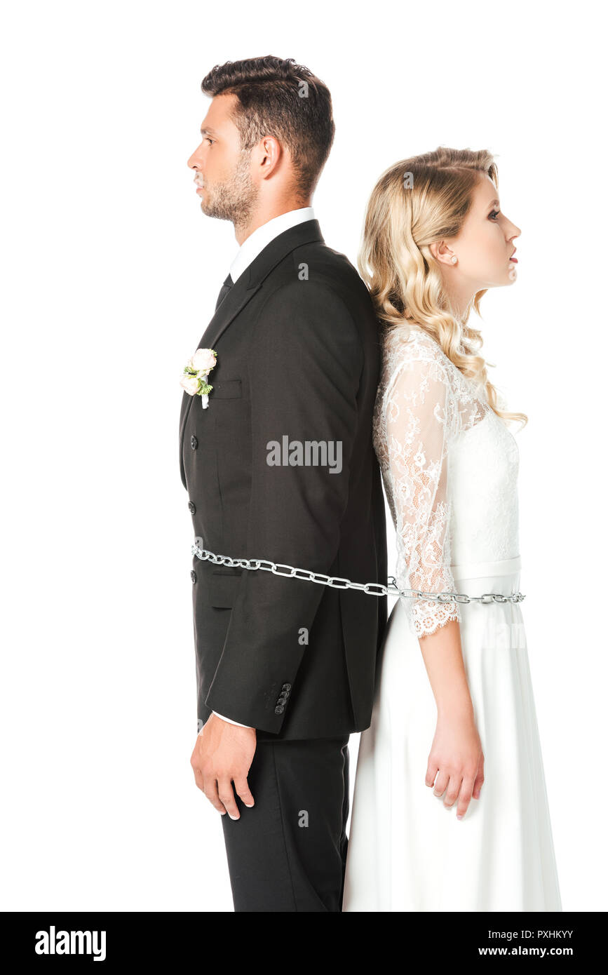 young newlyweds tied with chain back to back isolated on white Stock ...
