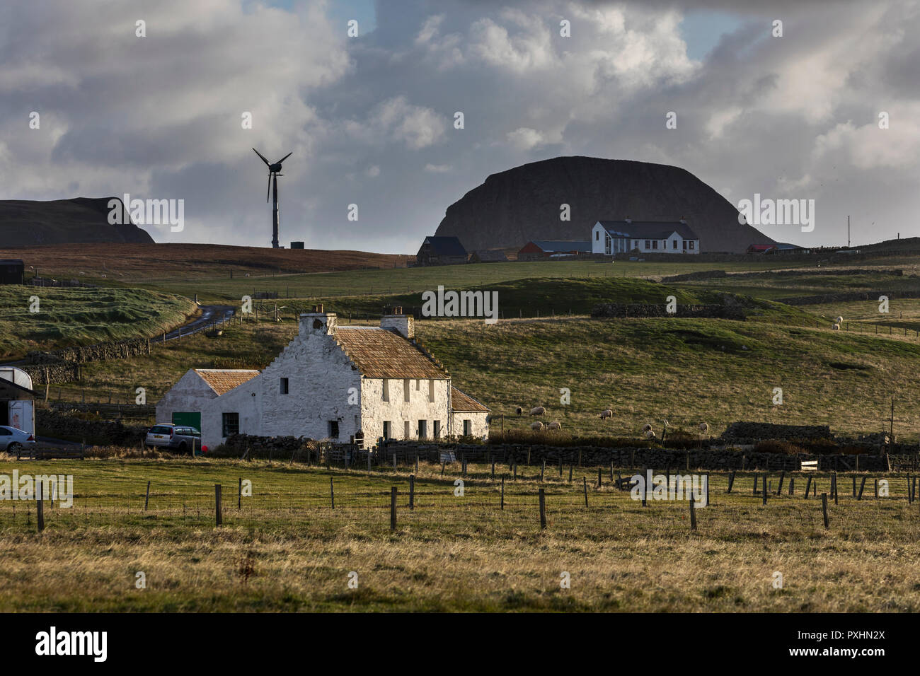 Fair Isle showing one of the new wind turbines and croft houses Stock ...