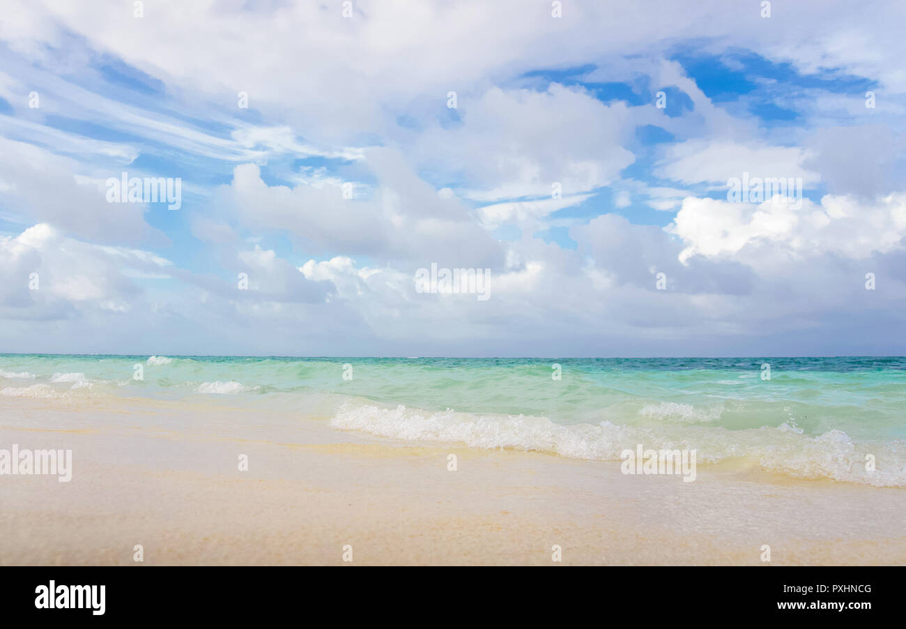 Topical beach seascape with turquoise warm waters and blue sky and ...