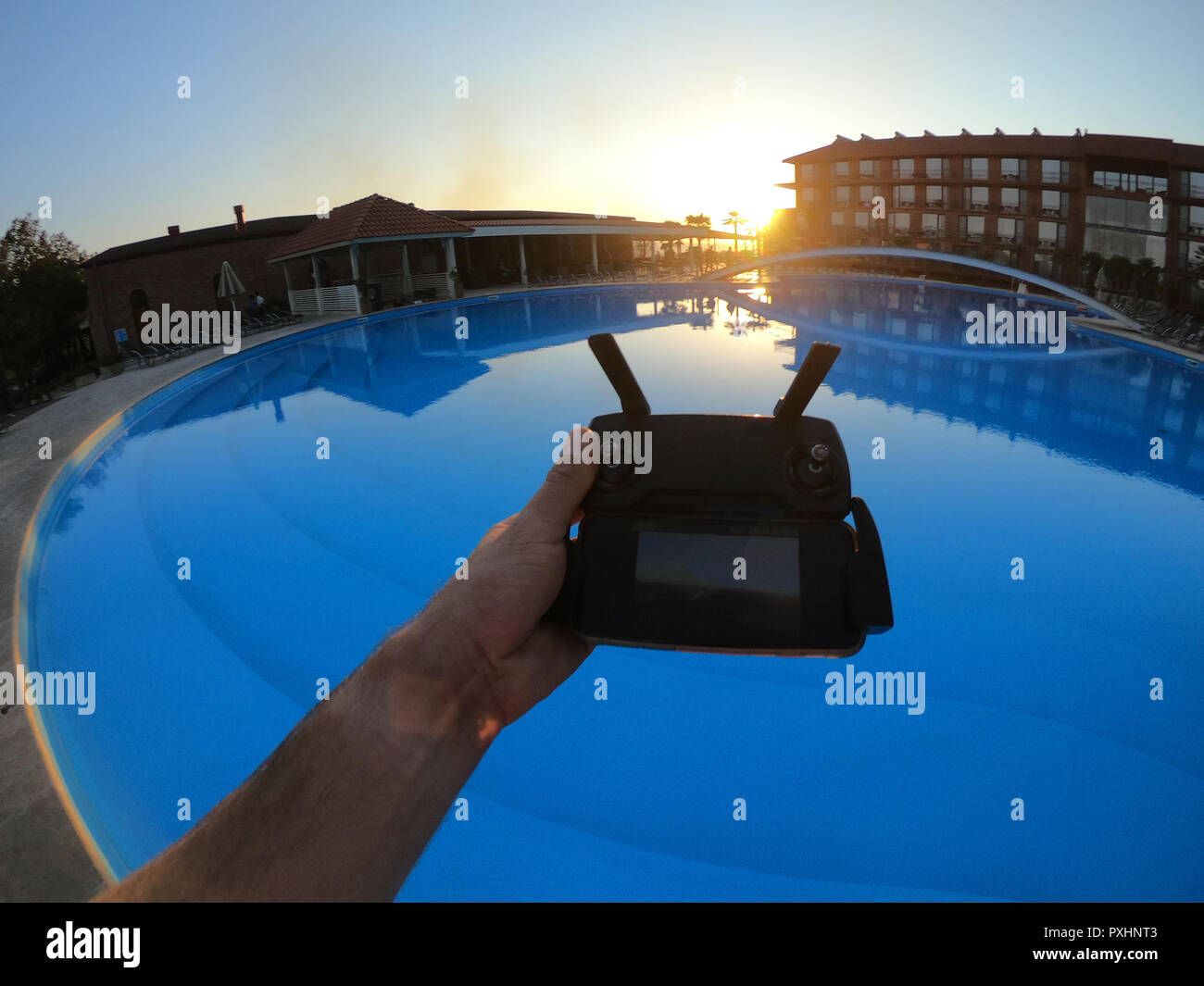 Drone remote by the pool at sunset in the hotel Stock Photo - Alamy