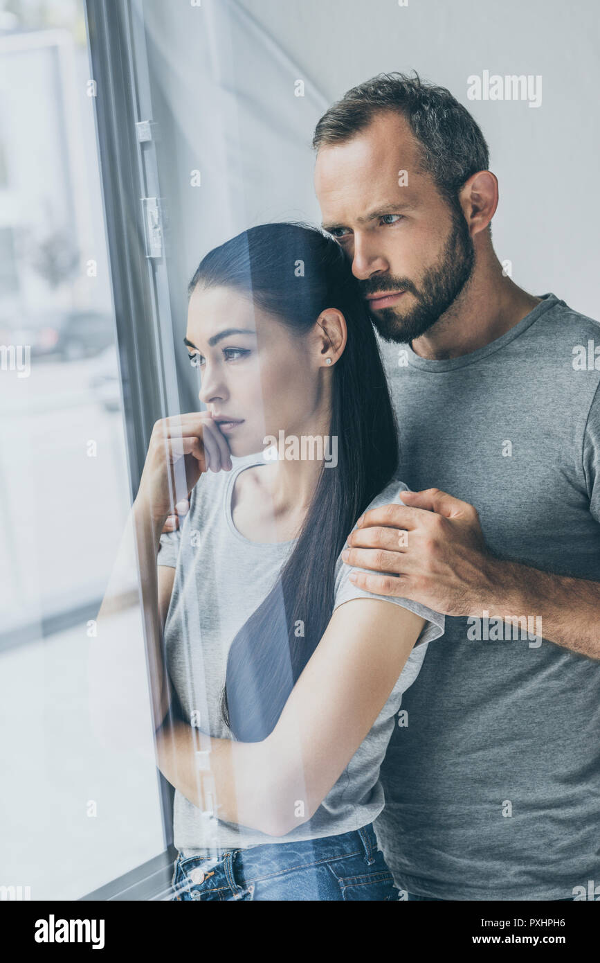 Sad attractive woman standing window hi-res stock photography and ...