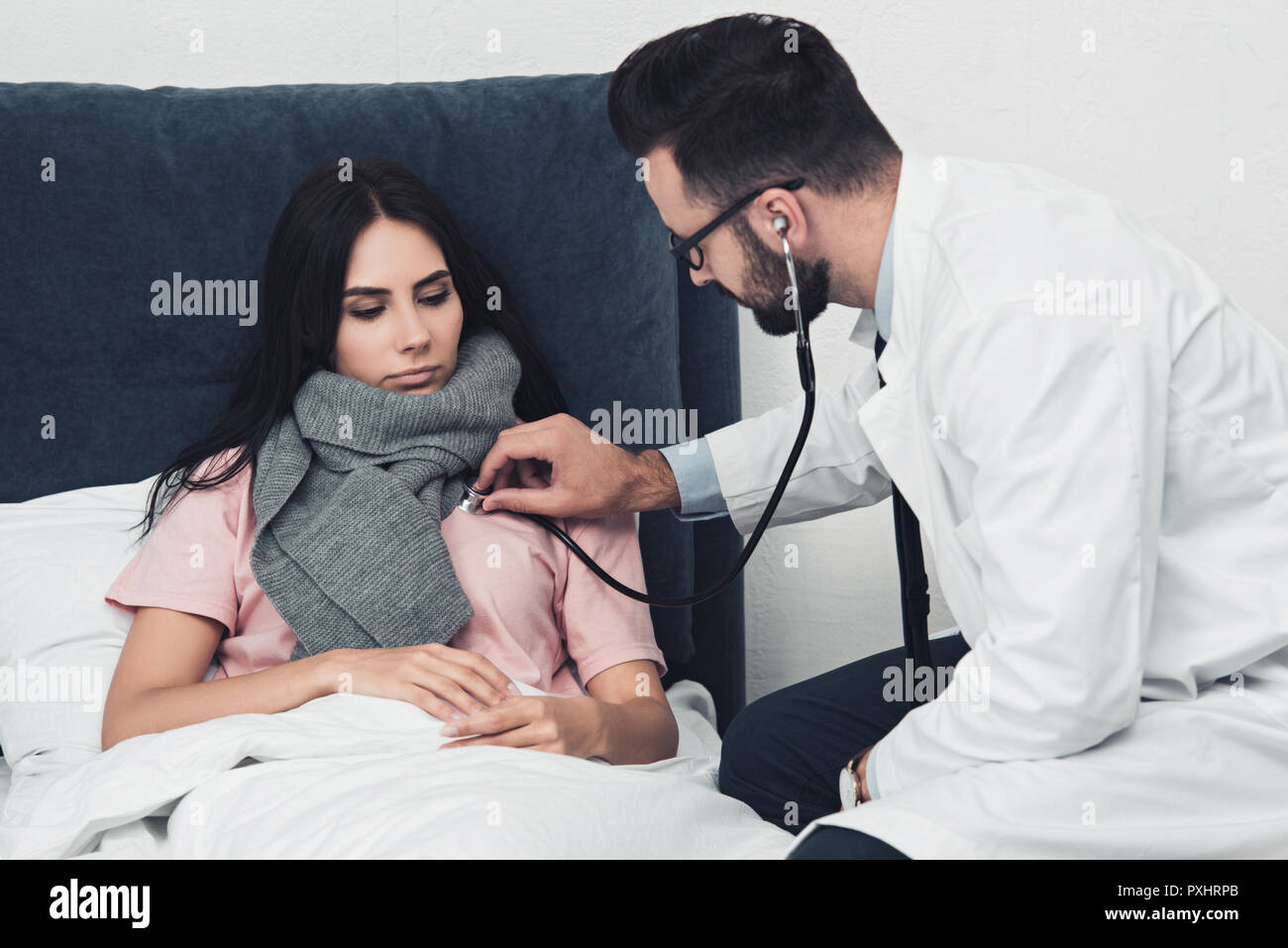 doctor listening breath of female patient while she lying in bed Stock ...