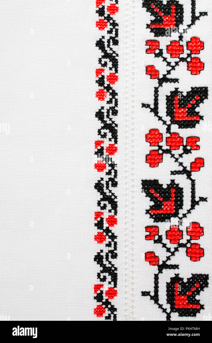 Ukrainian folk patterns embroidered with a cross on a white canvas ...