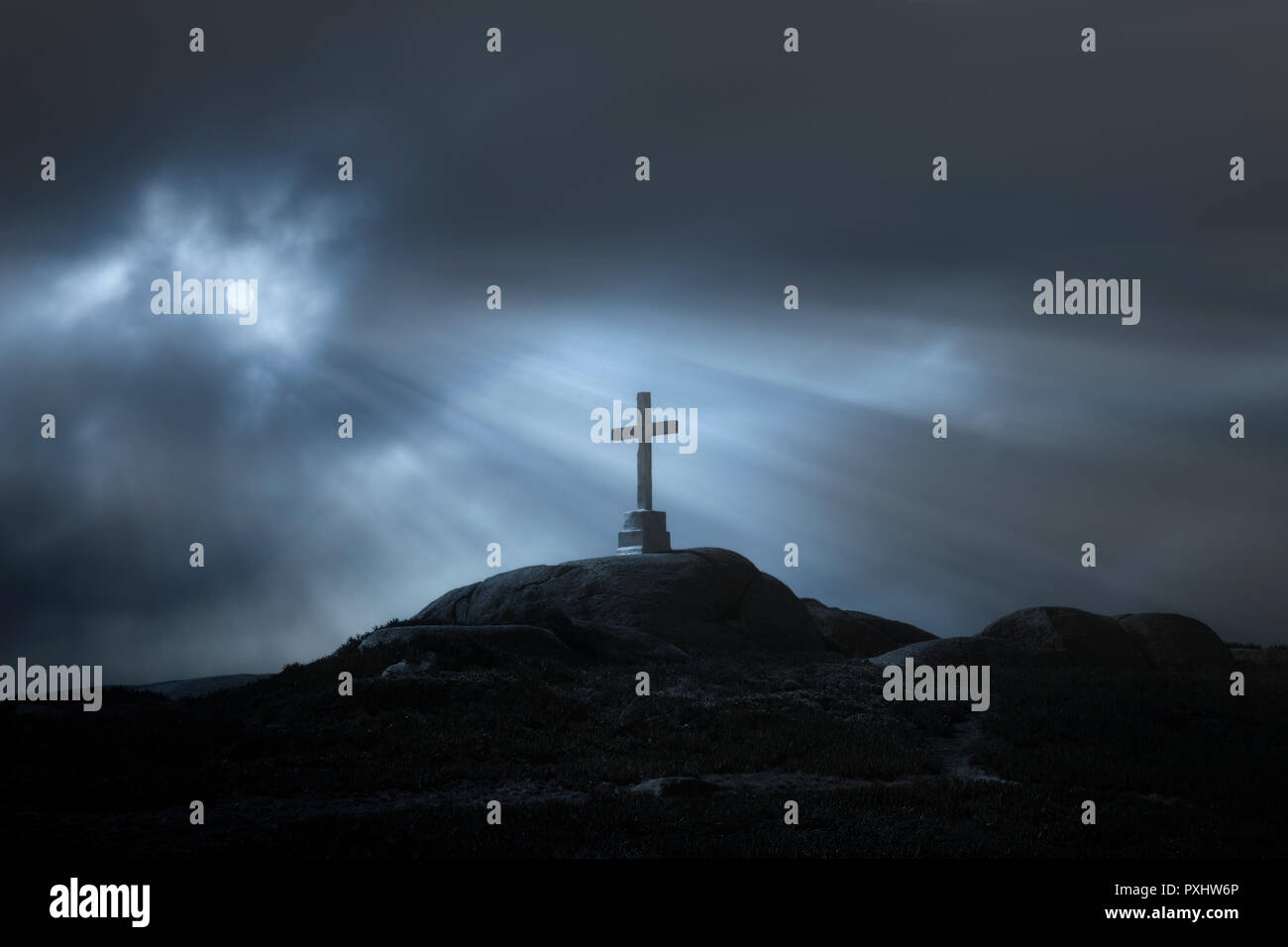 Mysterious cross in a hill against a cloudy full moon night with ...