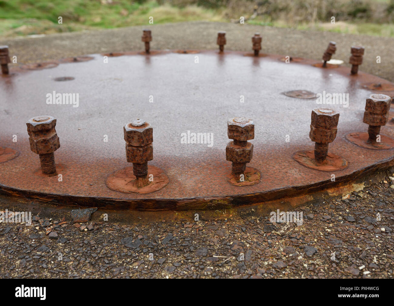 Rusty steel plate and rusty steel bolts and nuts on concrete base in ...