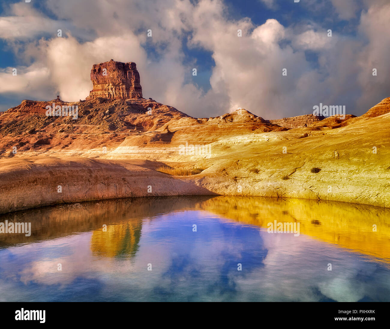 Hiker near reflection pool on banks of Lake Powell, Utah Stock Photo ...