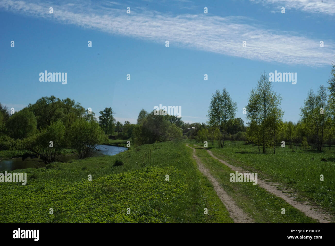 Long green lonely grass road in Moscow outskirts,spring Stock Photo - Alamy