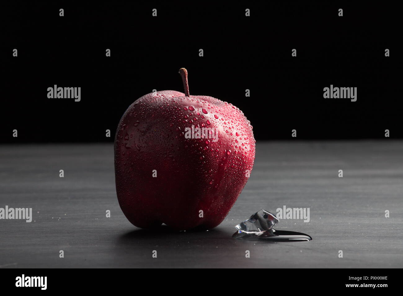 Apple and melting ice Stock Photo - Alamy