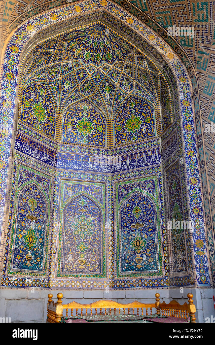 Bench in courtyard outside Shir Doh Madrasa in The Registan with blue ...
