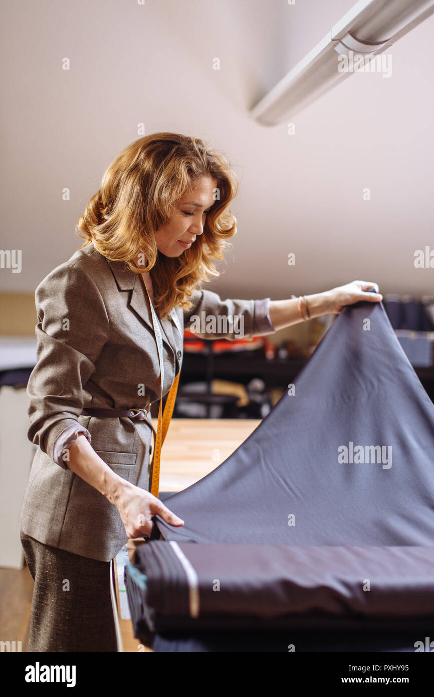 Dressmaker hands fabric tape measure hi-res stock photography and ...