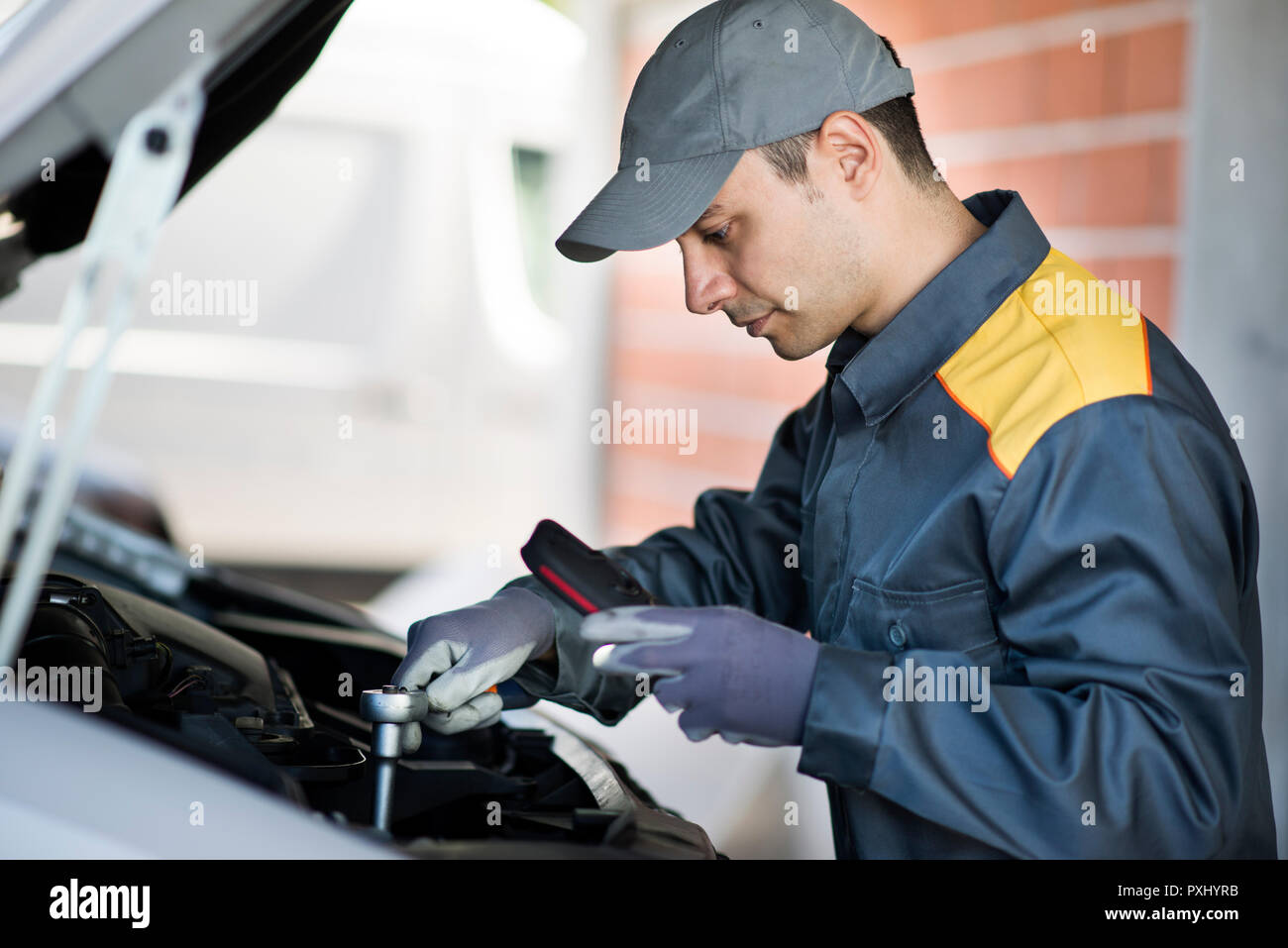 Mechainc fixing a van engine Stock Photo - Alamy