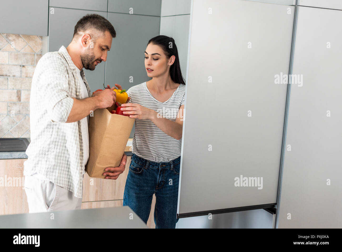 Woman putting food in fridge hi-res stock photography and images - Alamy