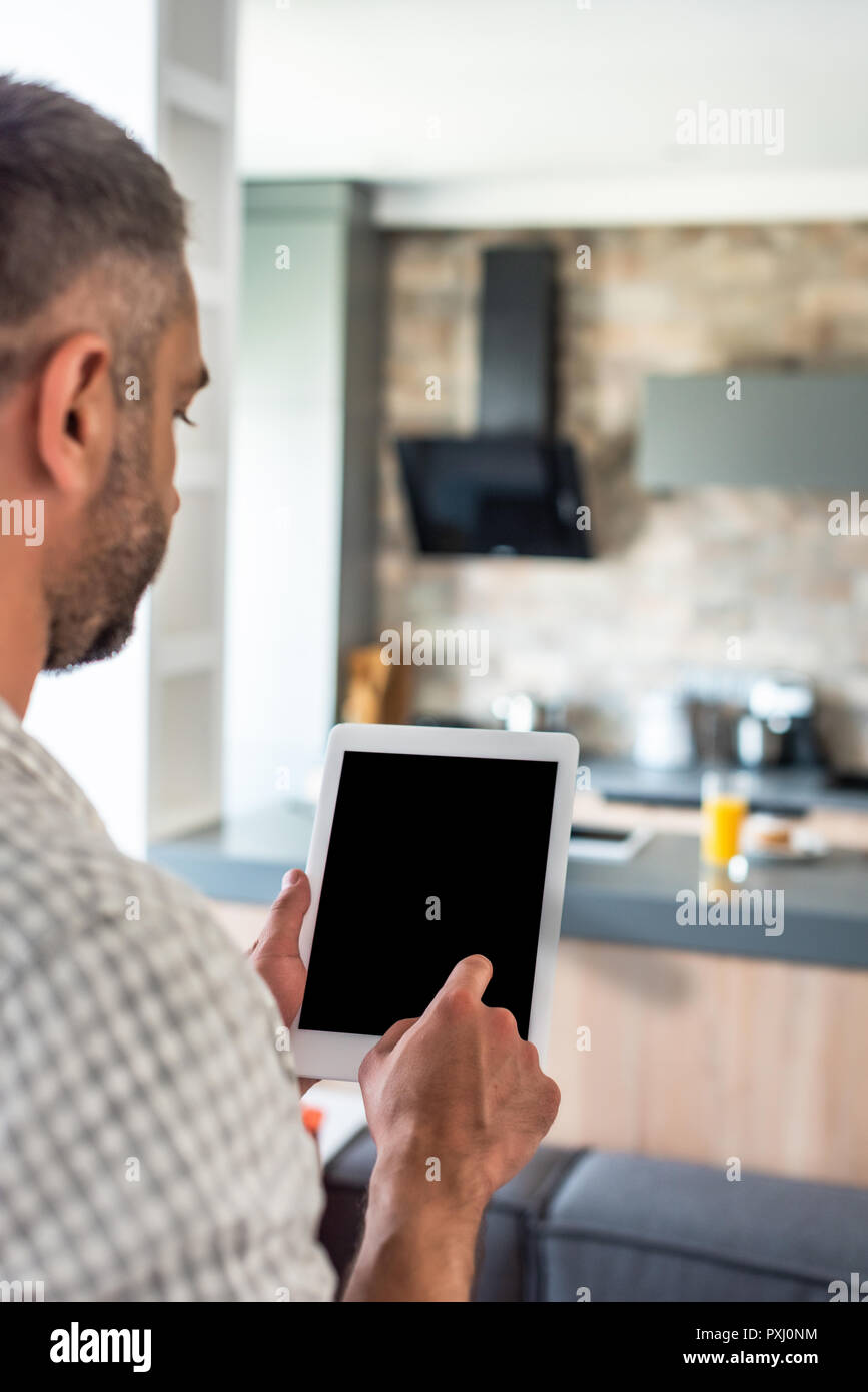 selective focus of man using tablet with blank screen in kitchen Stock ...
