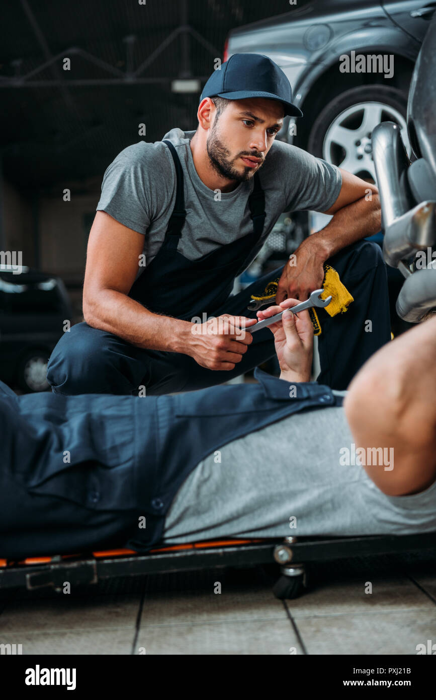 professional engineers working with tools in auto repair shop Stock ...