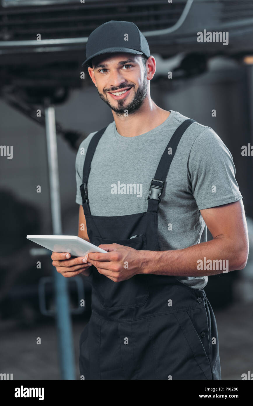 professional auto mechanic in overalls using digital tablet Stock Photo ...