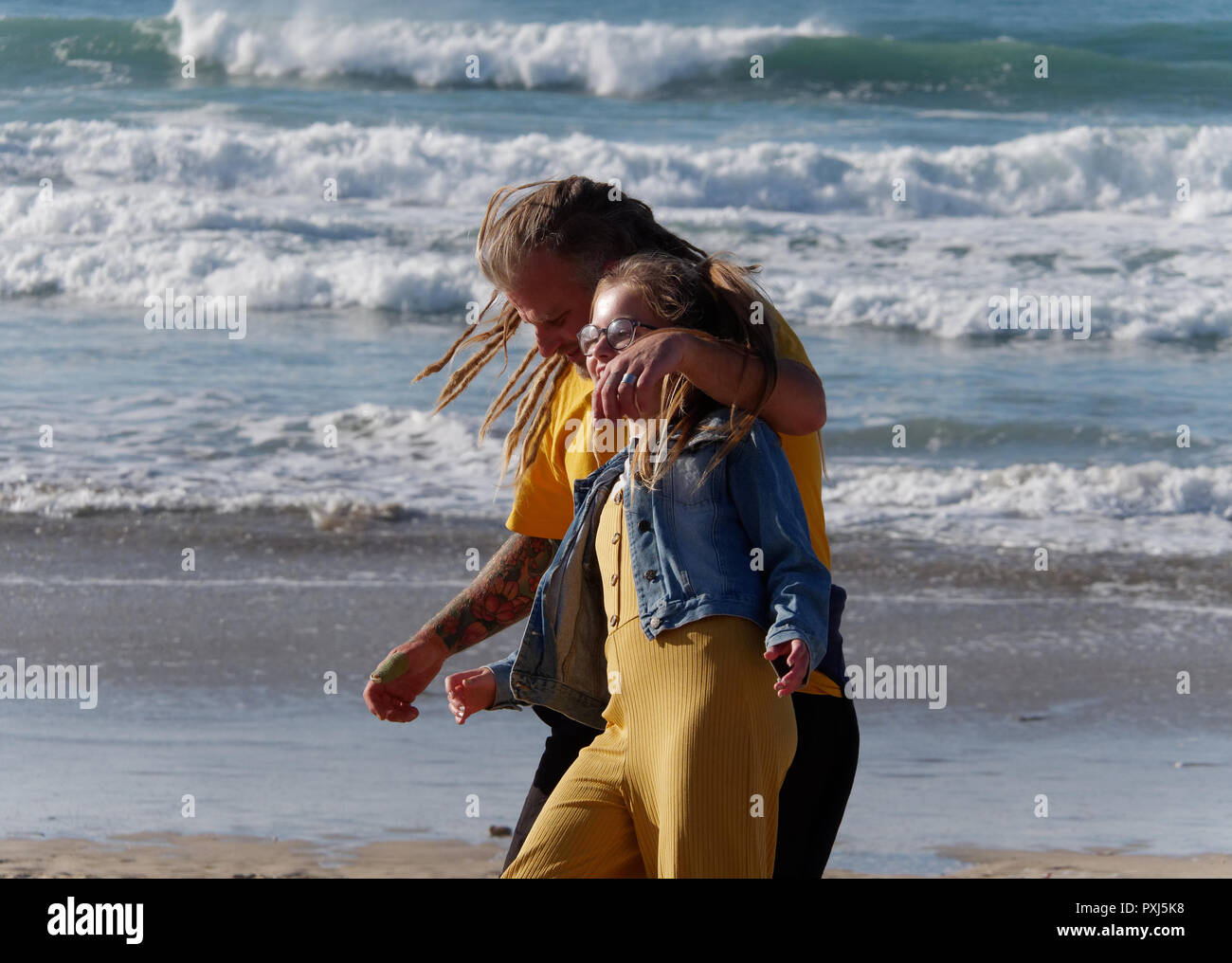 Beach individuals enjoy October sunshine at Fistral Beach cornwall UK ...