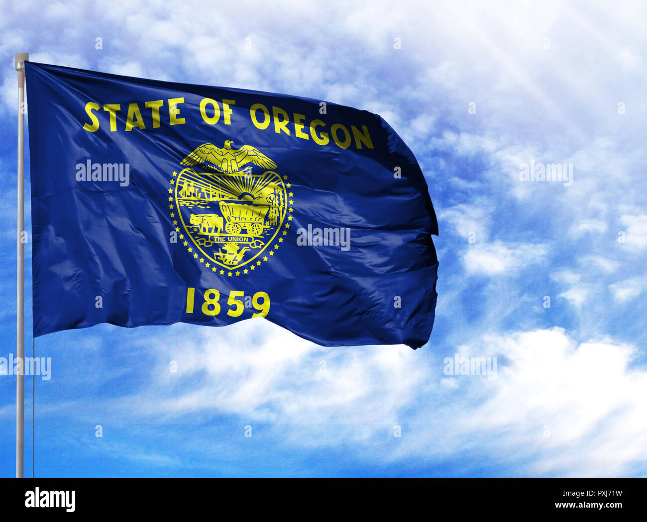 flag State of Oregon on a flagpole in front of blue sky Stock Photo - Alamy