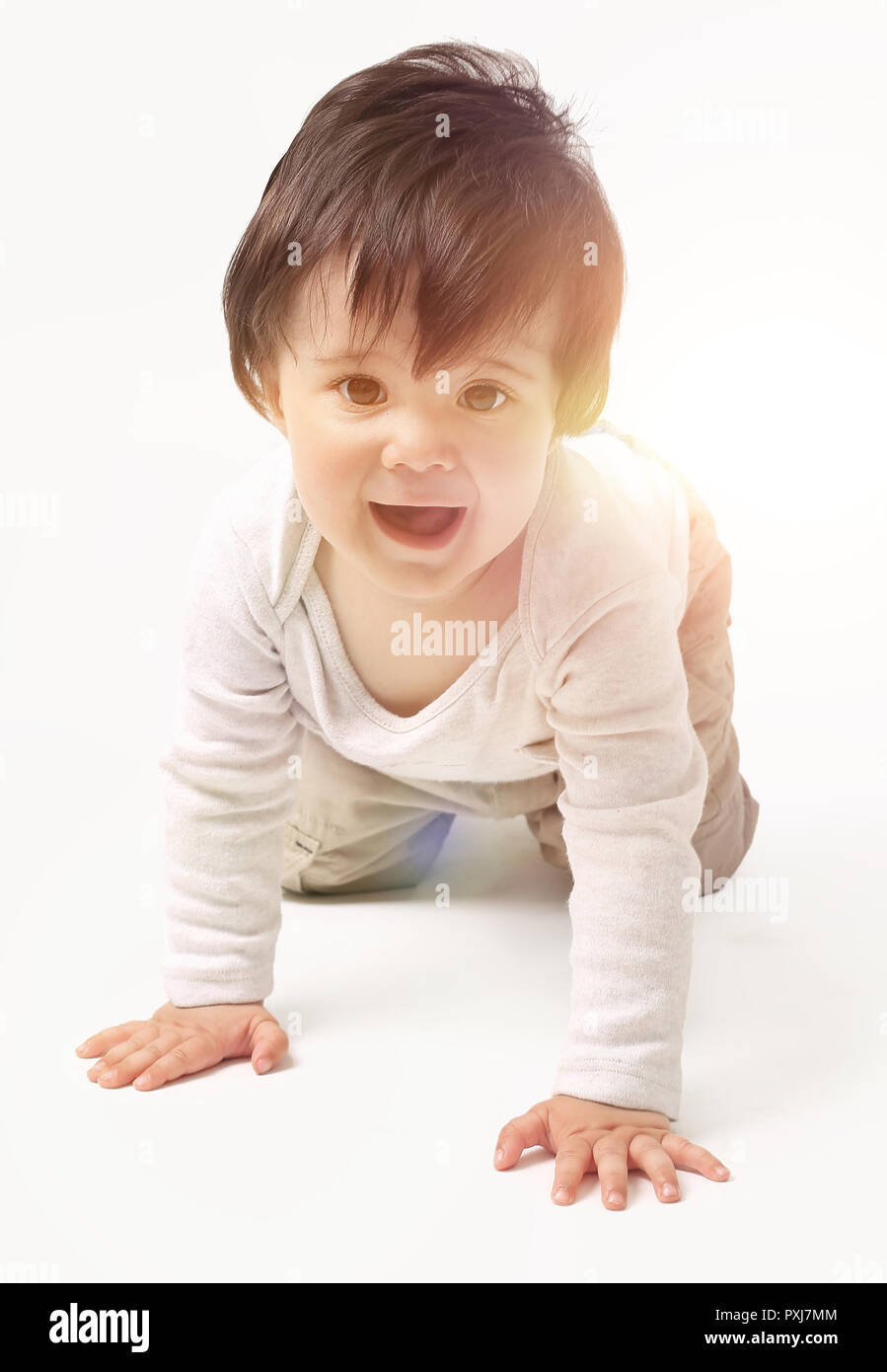 Smiling baby crawling forward Stock Photo - Alamy